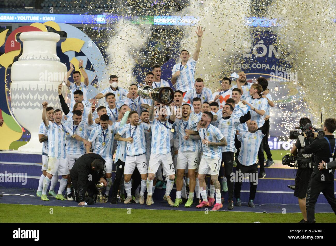 Argentina's Lionel Messi holds the trophy as he celebrates with ...