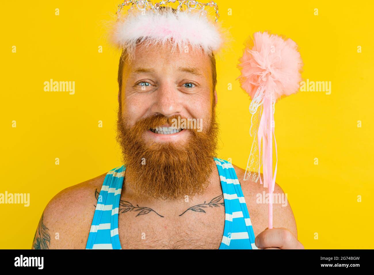Happy man with princess crown and magic wand acts like a fairy Stock ...
