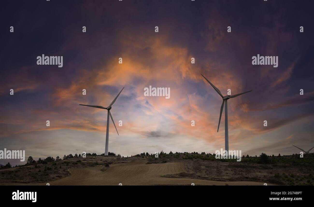 A beautiful landscape with windmills on a sunset sky background Stock ...