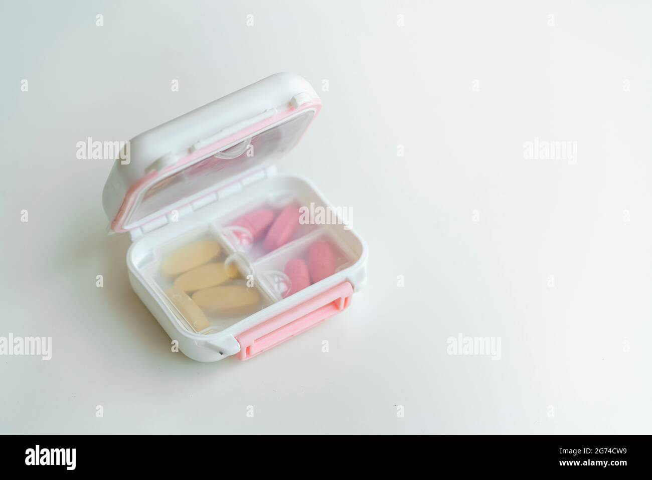 Opened pill box with vitamin supplements on white background Stock ...