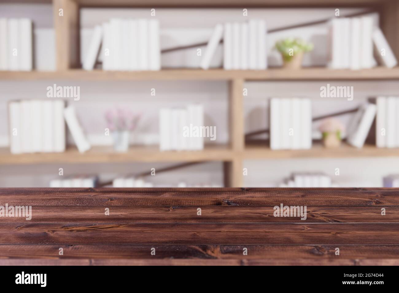 Library bookshelf blur background with blank wooden table space for ...