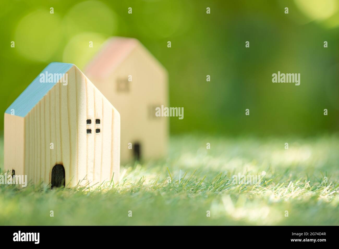 Small wooden home in green nature background for eco house village ...