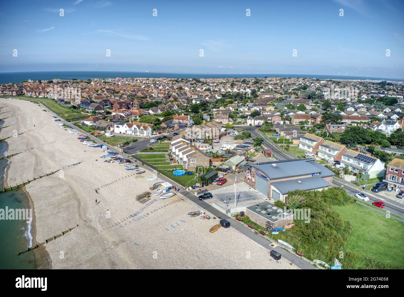 East Beach in Selsey West Sussex with small boats lined up on the wide ...