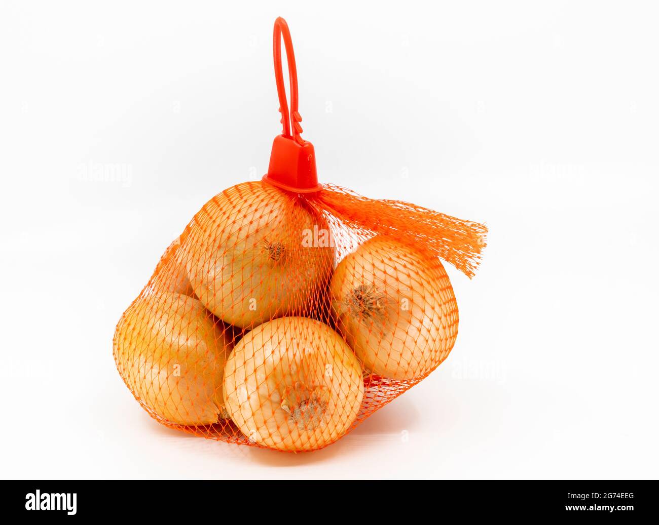 Isolated fresh organic onions in a red net bag on white background ...