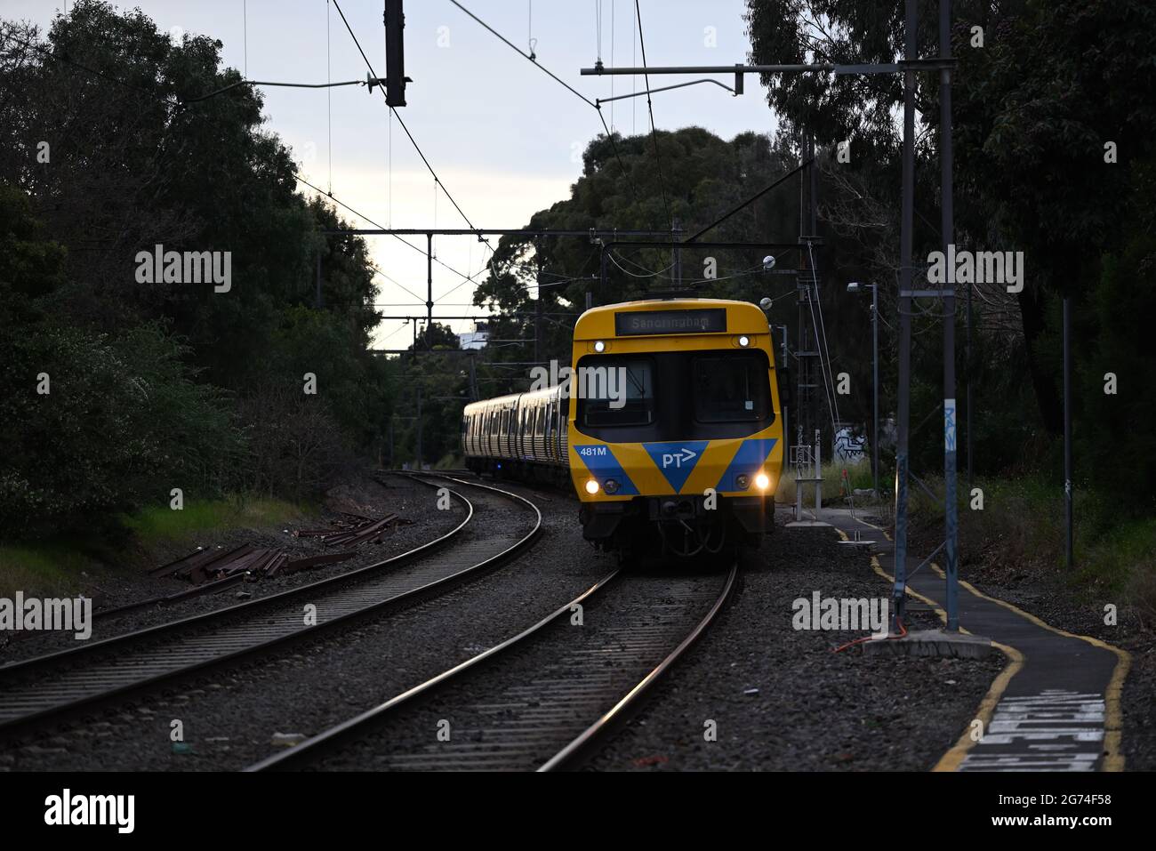 A Comeng train, part of the Metro Trains Melbourne fleet, rounds a bend ...