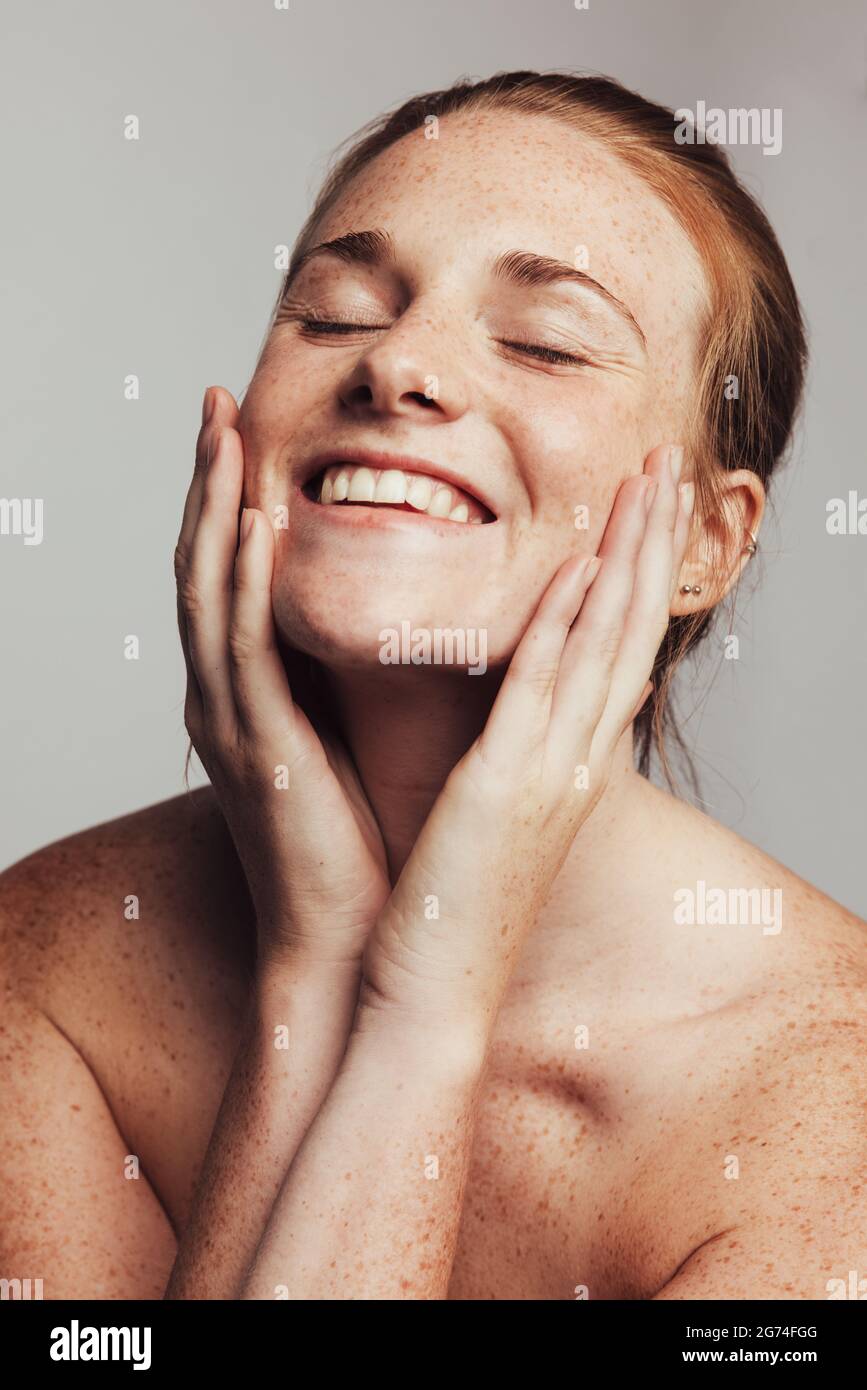 Portrait of happy woman with freckles on body. Close up of smiling ...