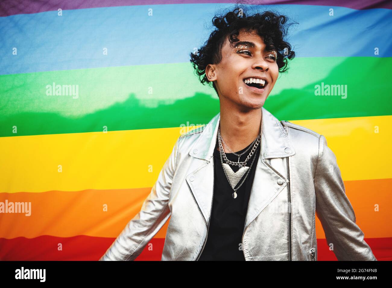 Gay man celebrating his queer identity. Happy young gay man smiling ...