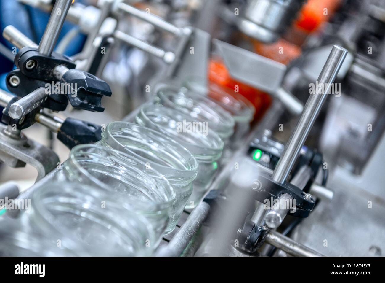 Machine for filling red caviar into glass jars. Filling equipment, food ...