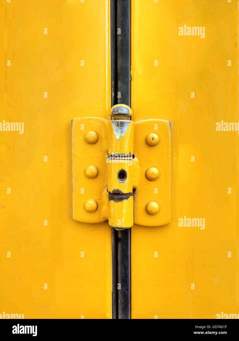 The painted hinge of a yellow door Stock Photo - Alamy