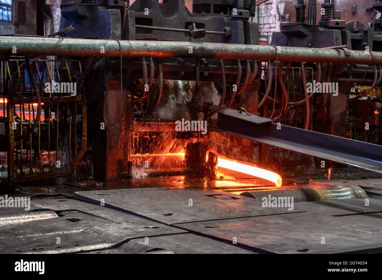 The process of rolling hot rolled steel in a rolling mill Stock Photo ...