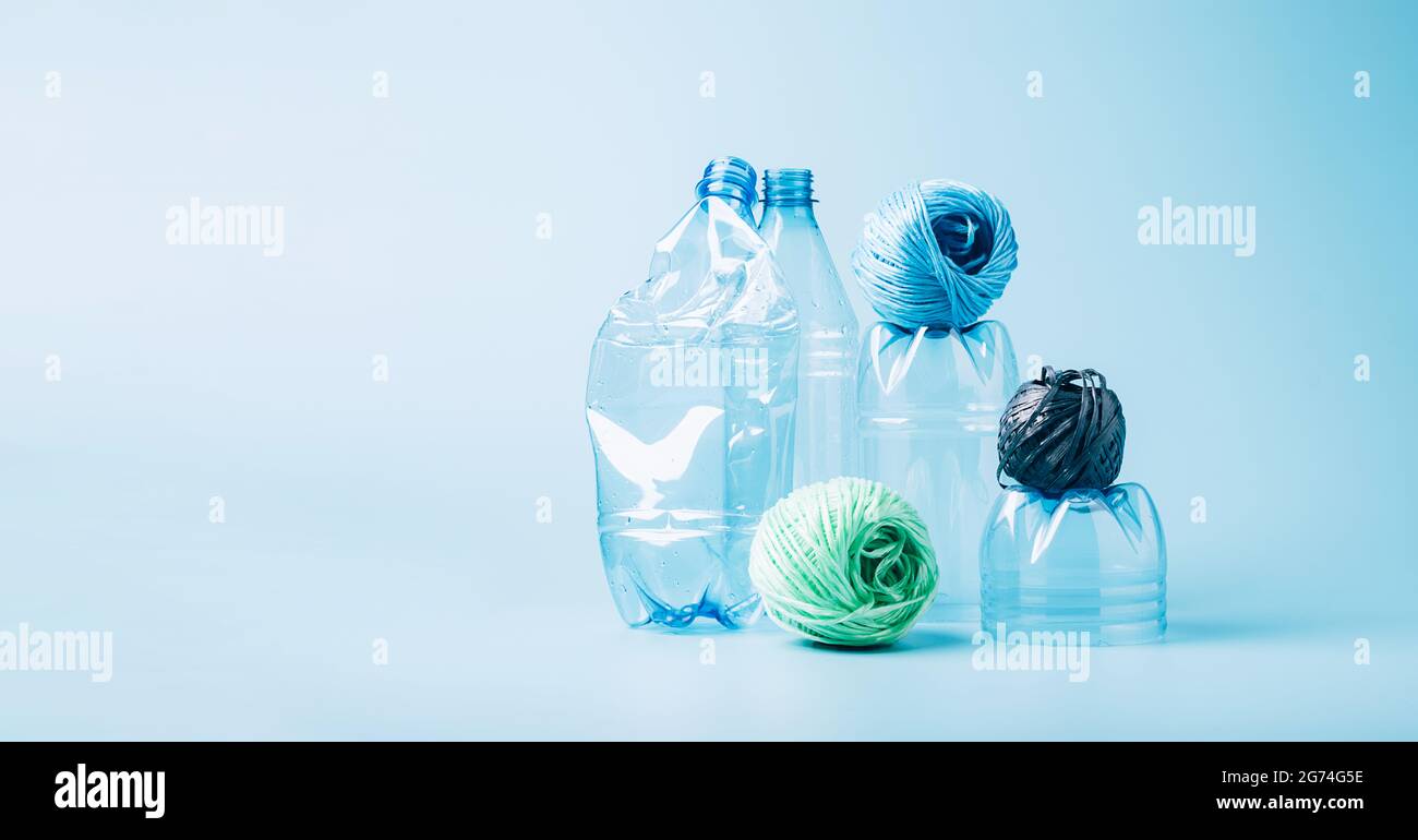 Plastic recycling and reuse concept. Empty plastic bottle and polyester ...