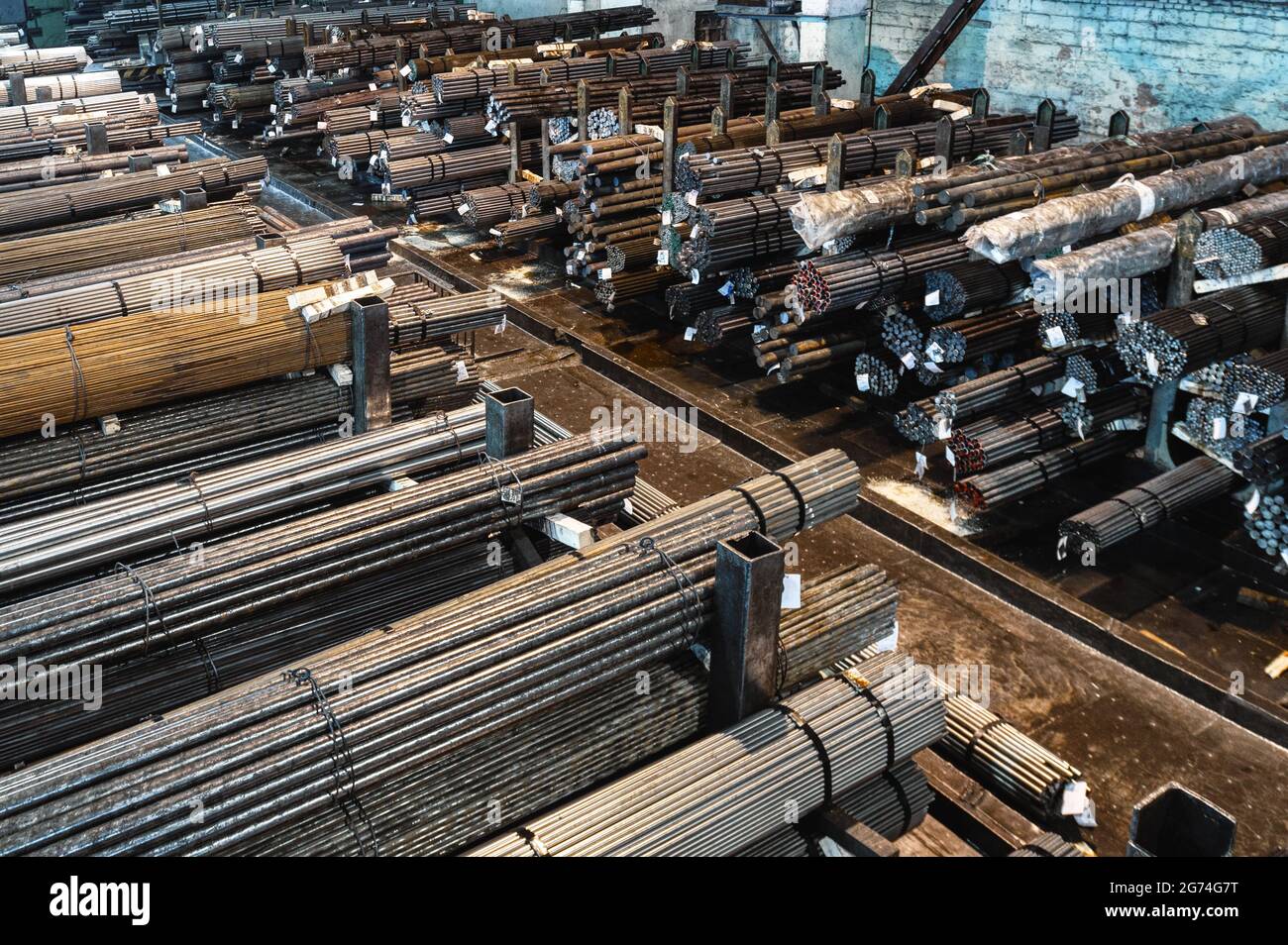 Rolled metal warehouse. Many packs of metal bars on the shelves Stock ...