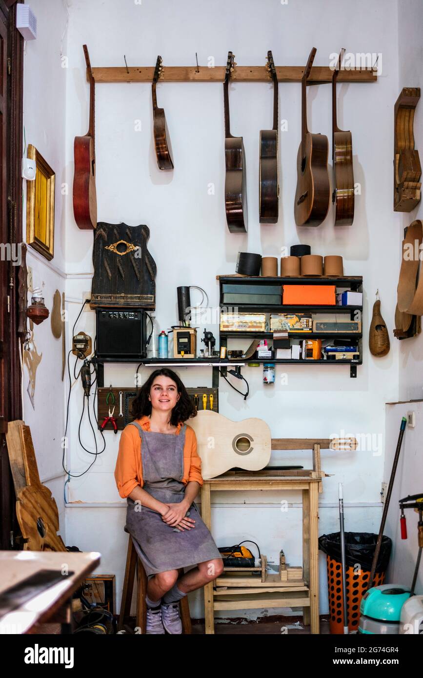 woman luthier making guitars in her musical instrument workshop Stock ...