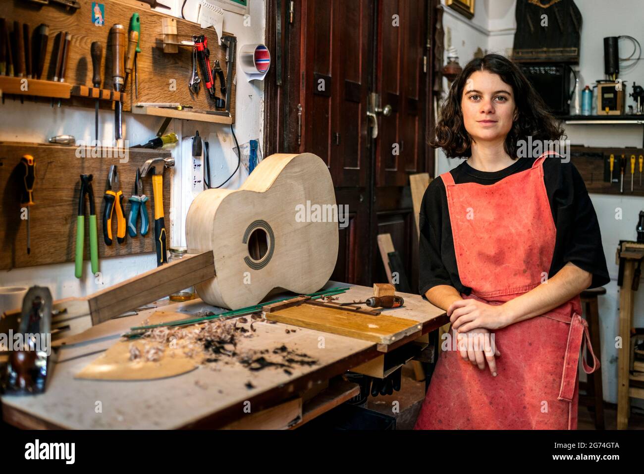 woman luthier making guitars in her musical instrument workshop Stock ...