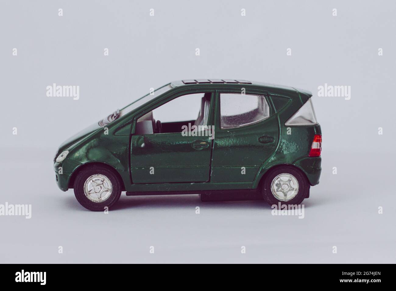 A side view of a green minibus with black wheels Stock Photo - Alamy