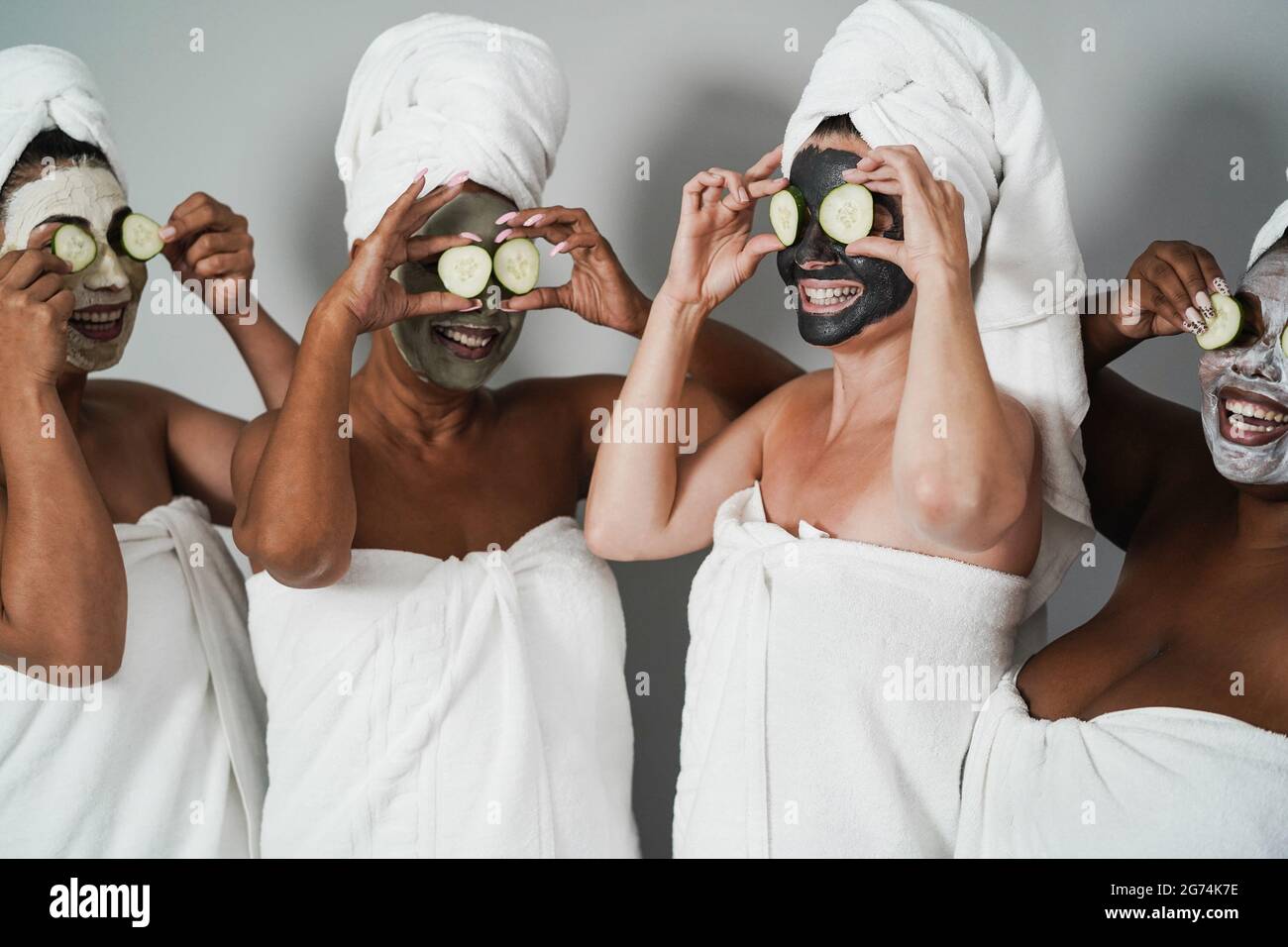 Multigenerational women having fun wearing face beauty mask with ...