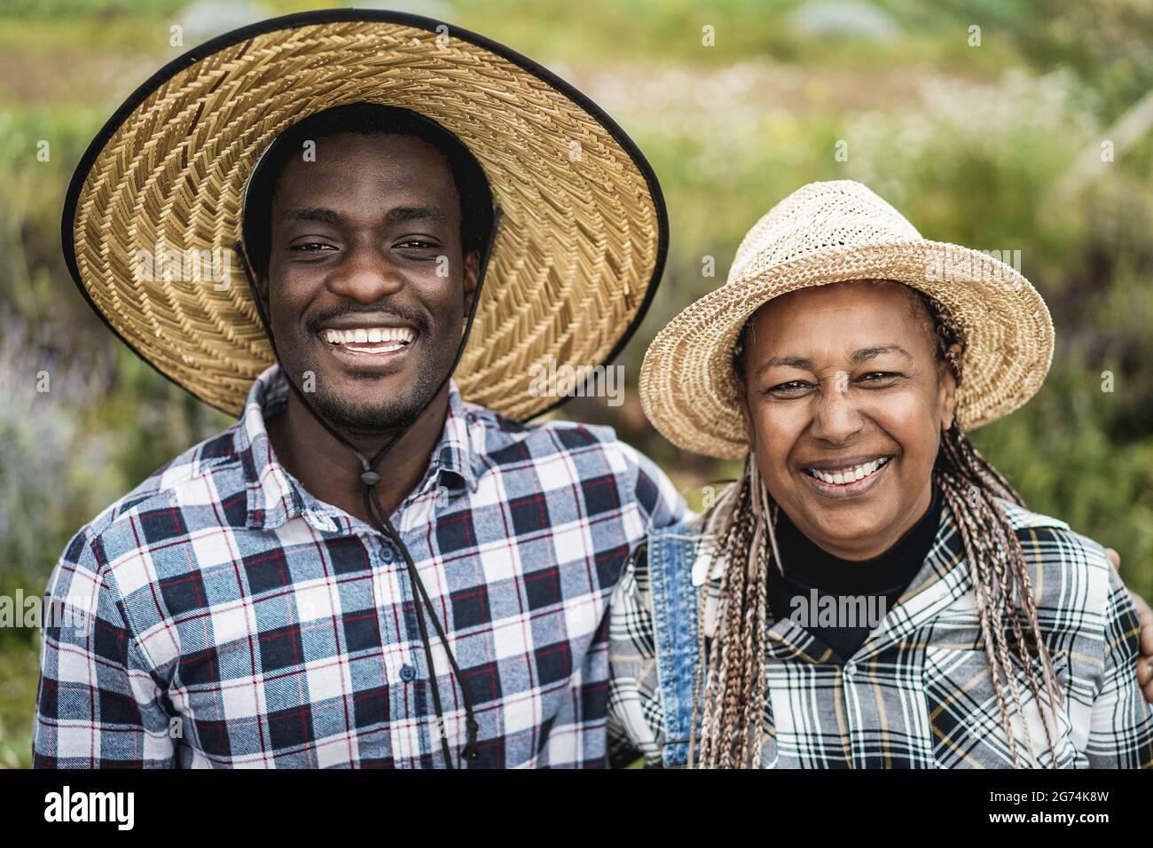 African american farmers smiling on camera during harvest period ...