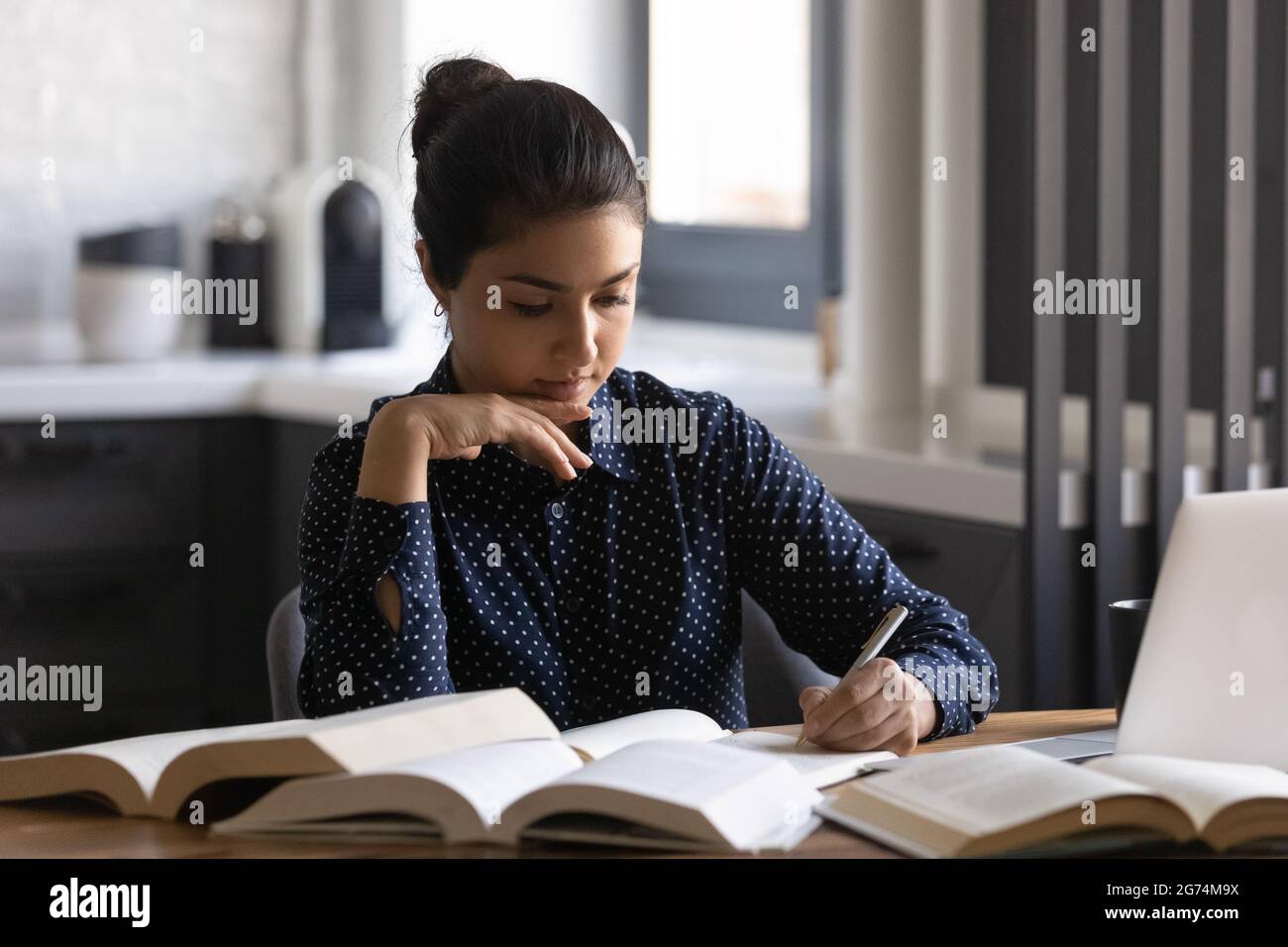 Focused millennial Indian student girl studying from home Stock Photo ...