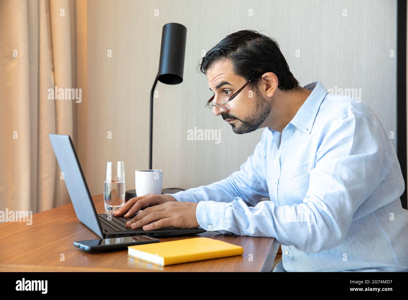 middle aged man with a poor eyesight working in his computer Stock ...
