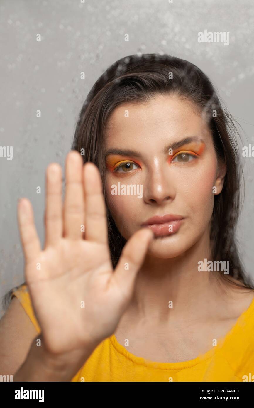 Woman says goodbye through rainy windows Stock Photo - Alamy