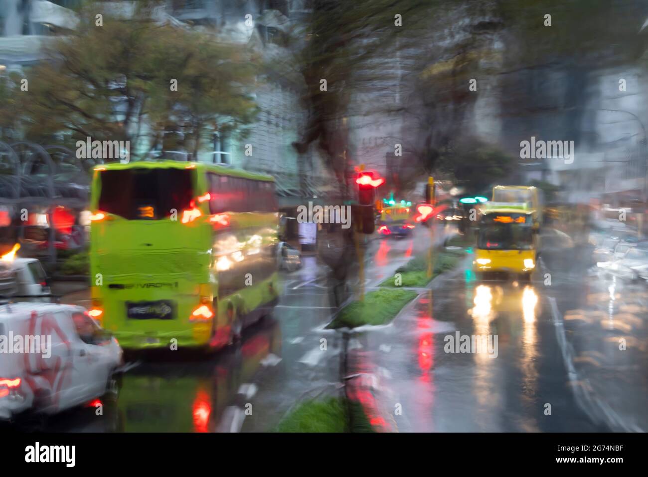 Cars and Buses on city street in heavy rain, Wellington, North Island ...