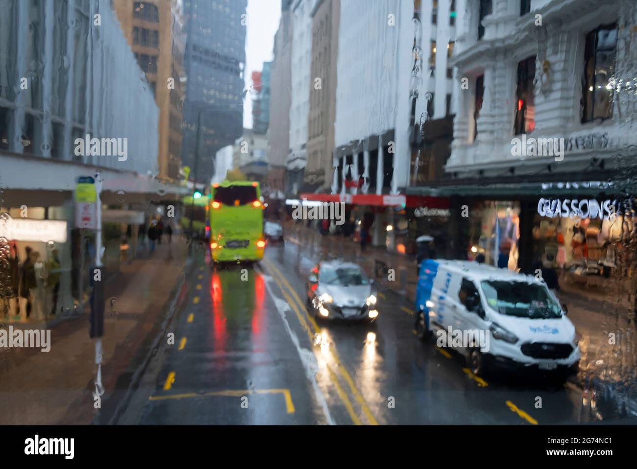 Cars and Buses on city street in heavy rain, Wellington, North Island ...