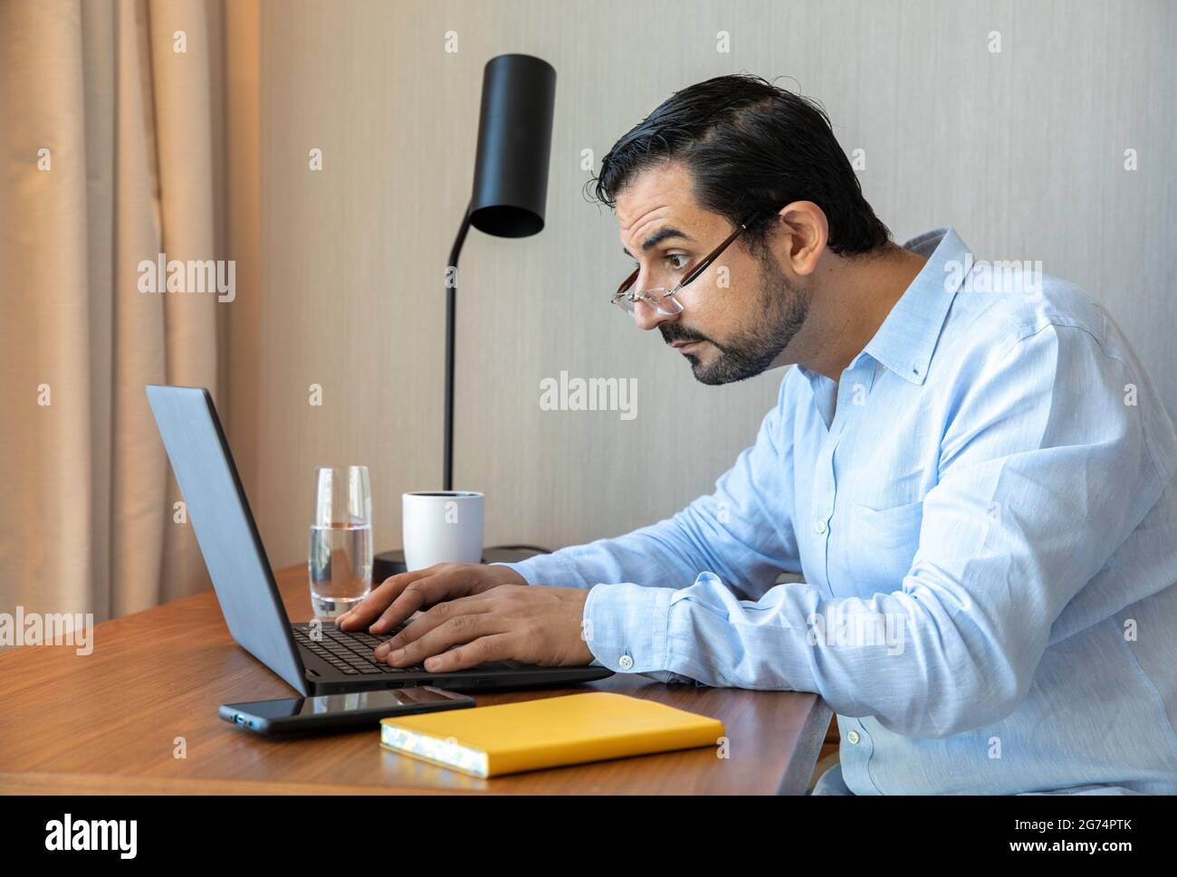 middle aged man with a poor eyesight working in his computer Stock ...