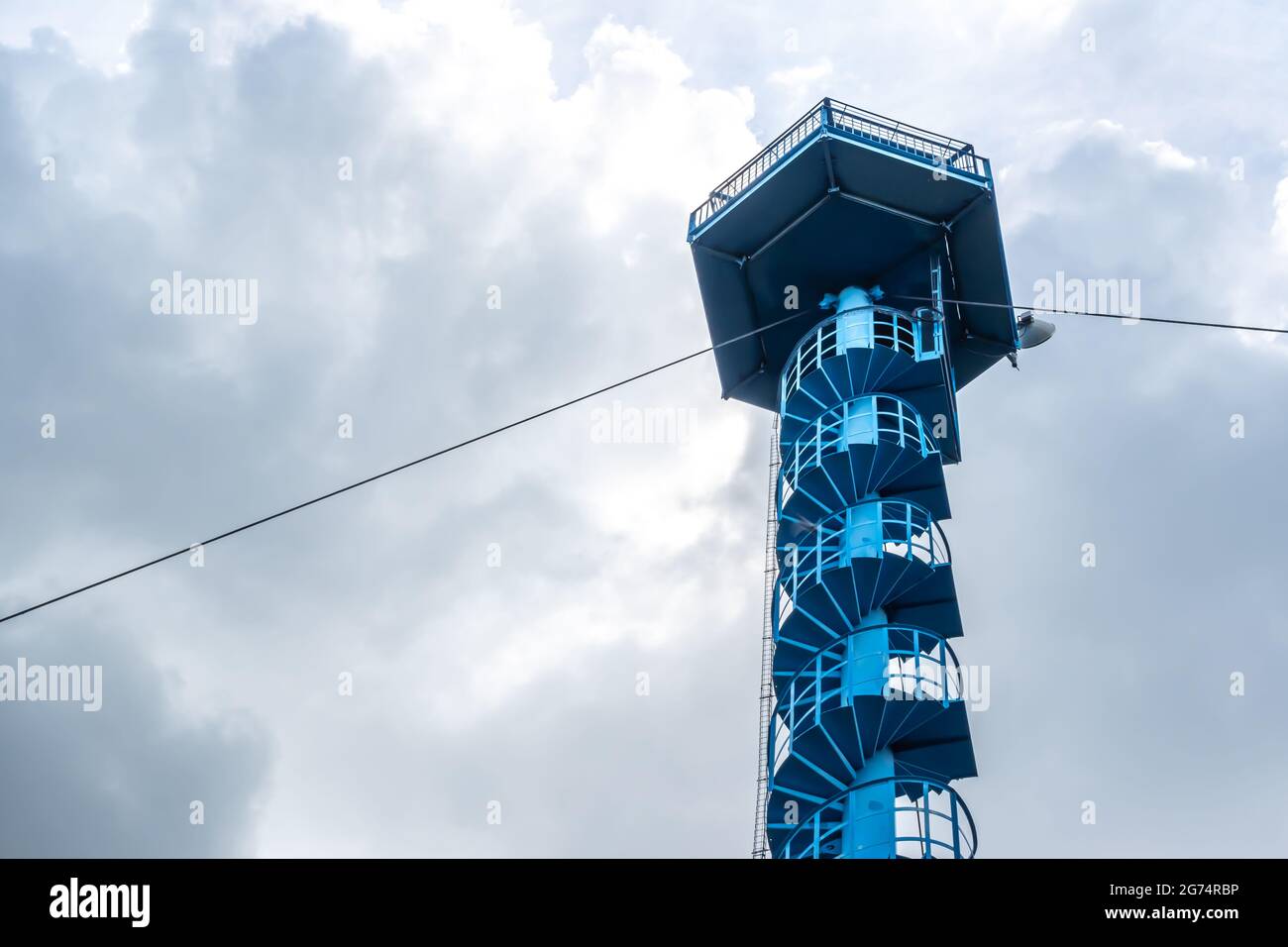 High fire watchtower in the forest. Photo taken on a cloudy day with ...
