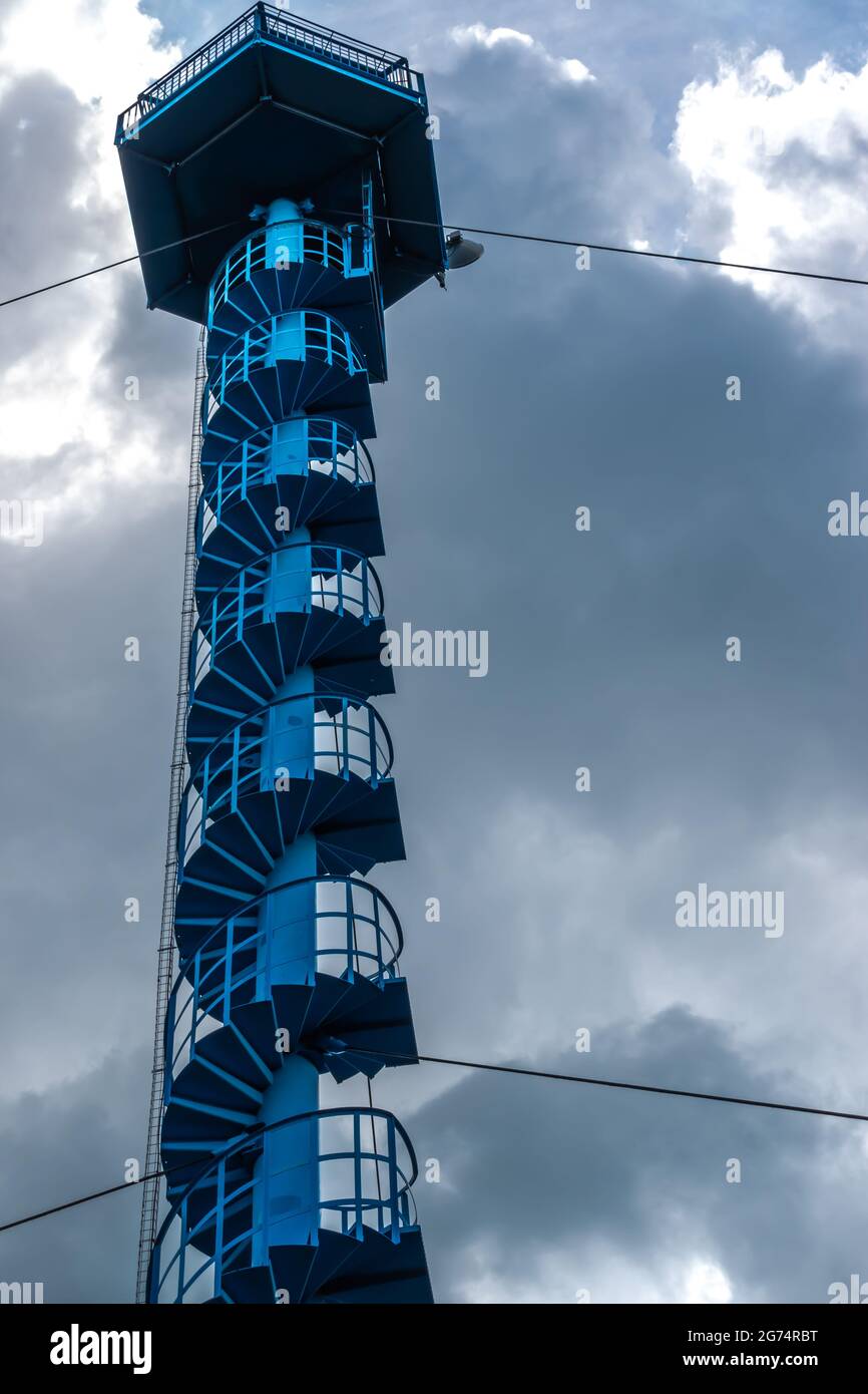 High fire watchtower in the forest. Photo taken on a cloudy day with ...