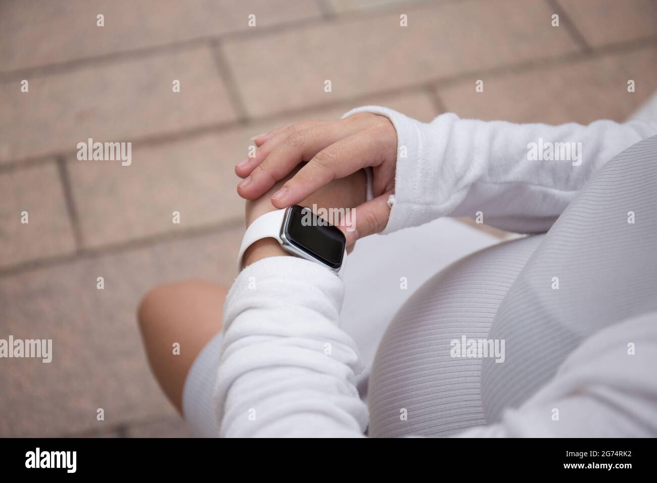 A high angle shot of a Southeast Asian pregnant female looking at her ...