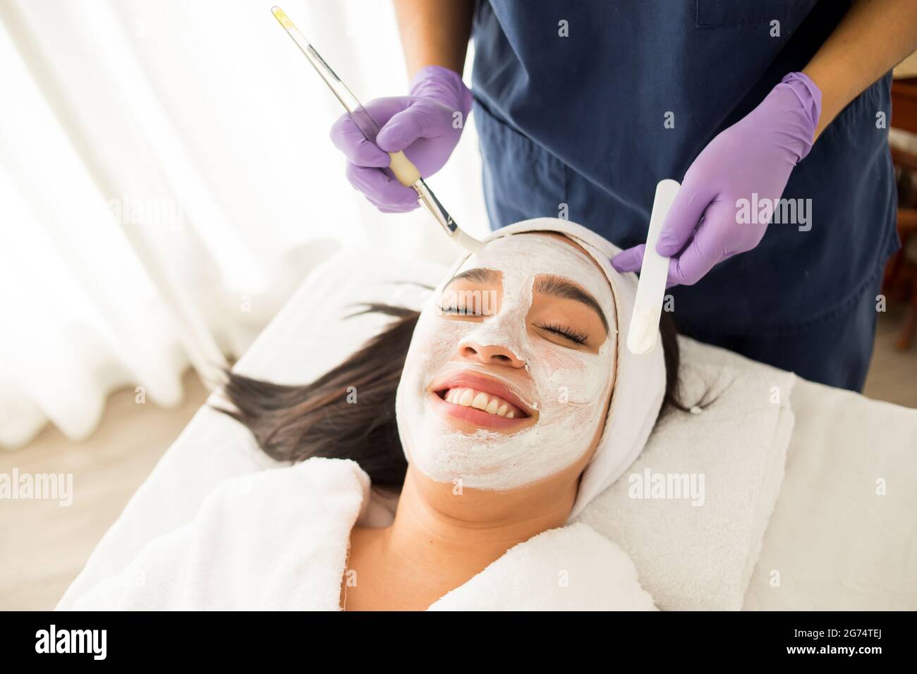 A Spanish female taking spa facial treatment Stock Photo - Alamy