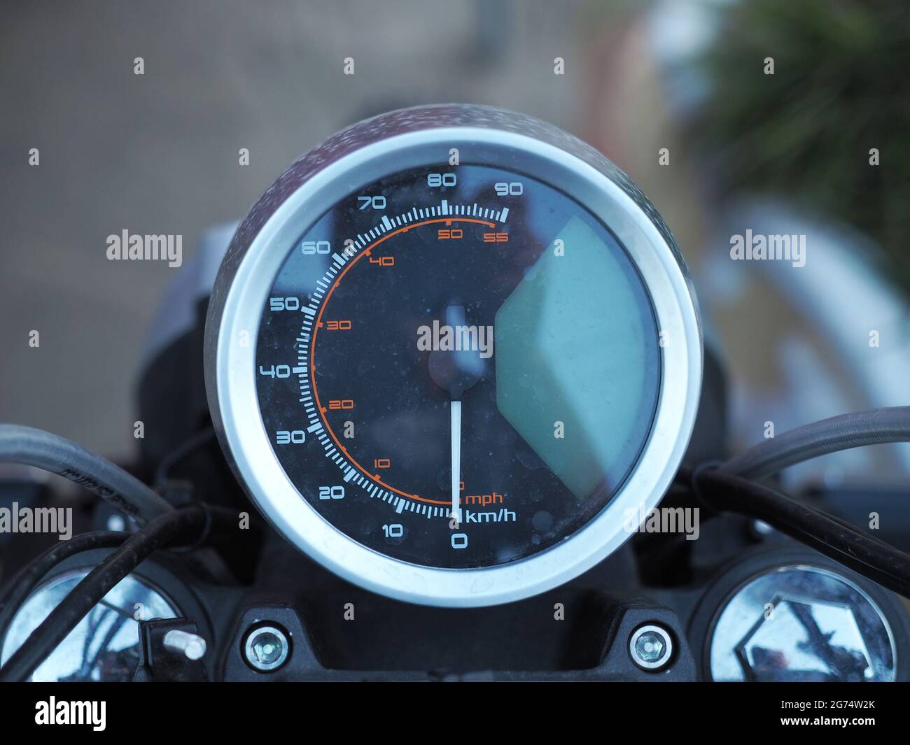 Round spattered motorcycle speedometer. Front view. Closeup photo with ...
