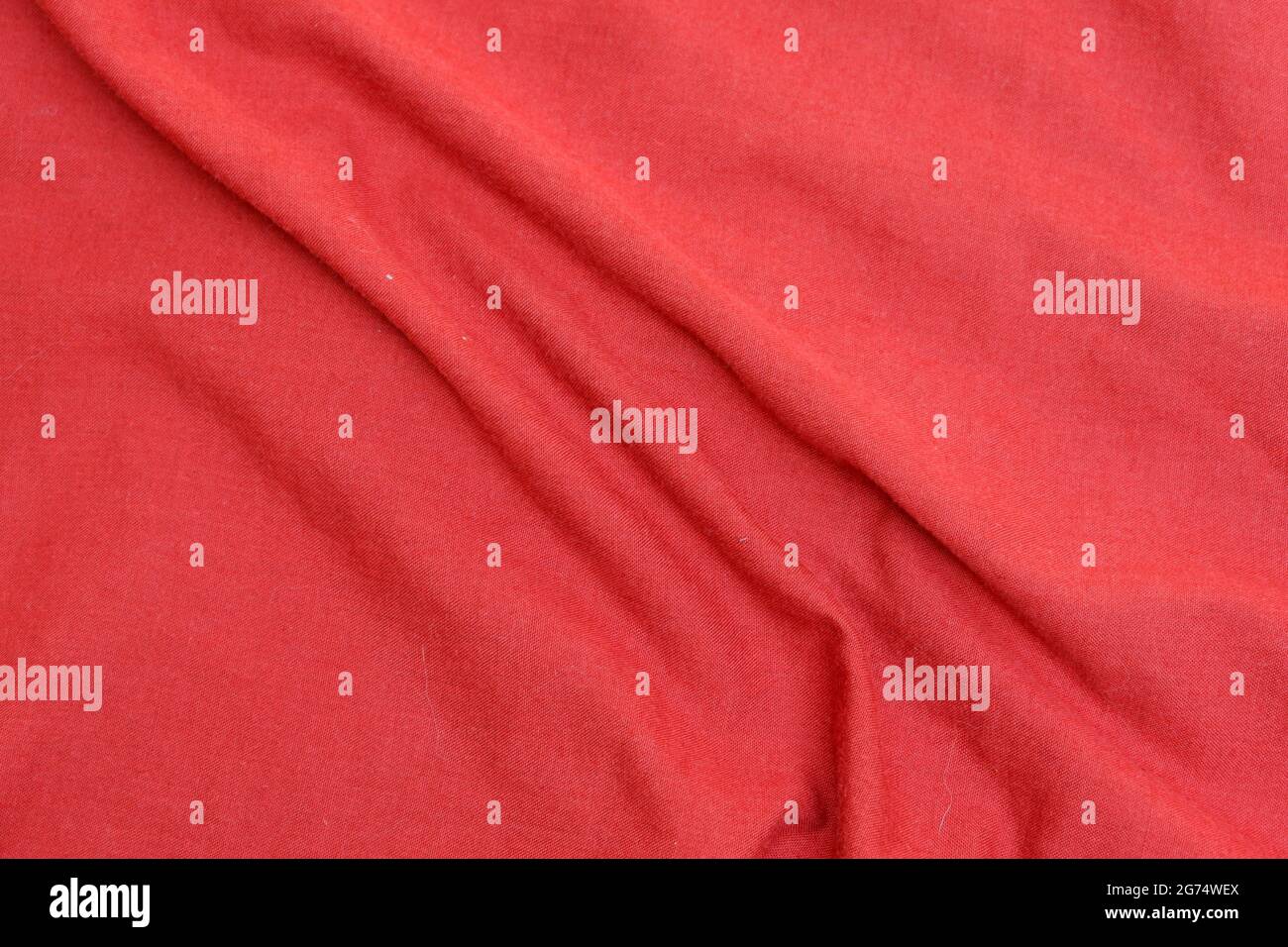 A top view closeup of a wrinkled red cloth texture for a background ...