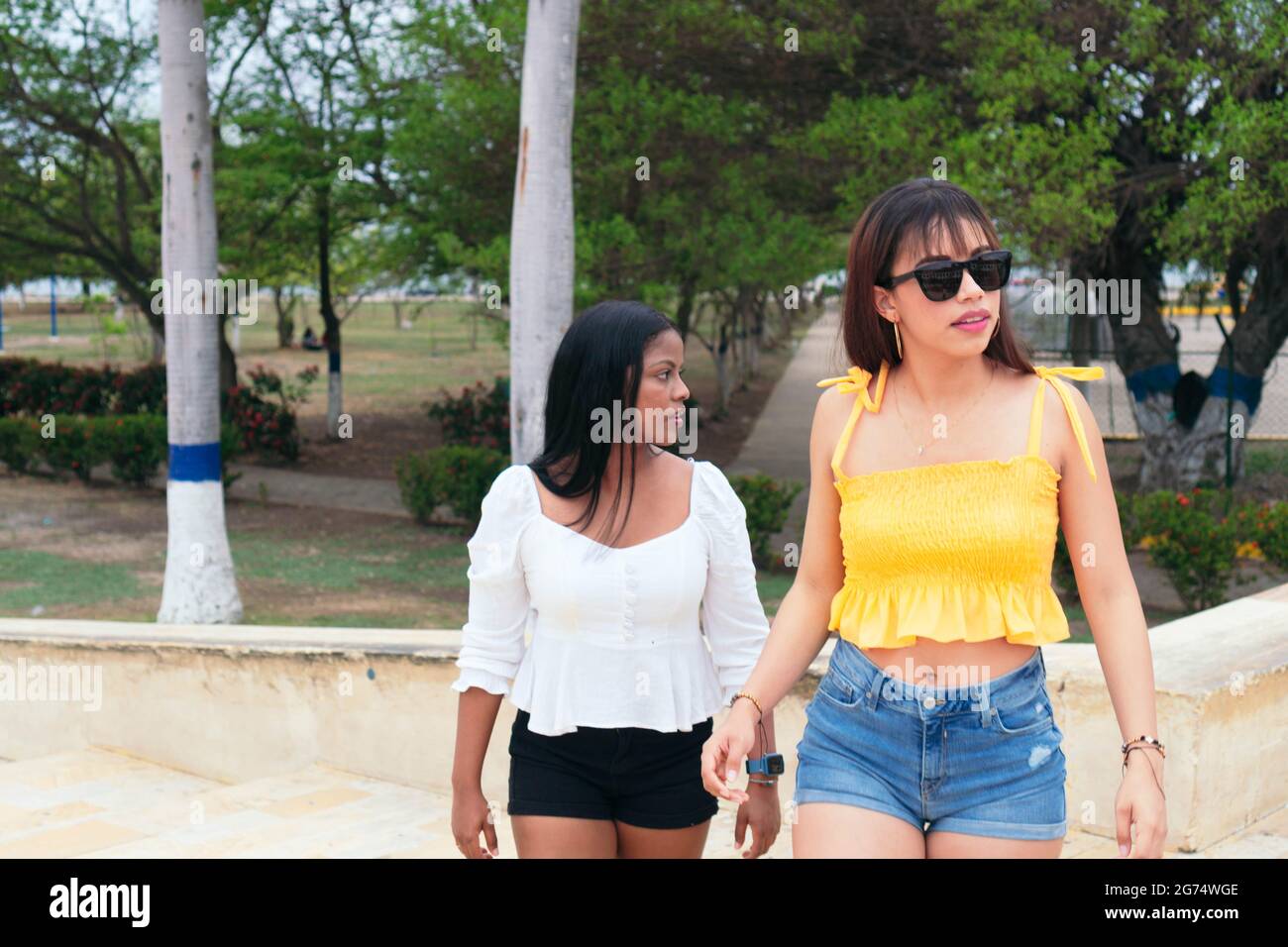 Two friends walking together hi-res stock photography and images - Alamy