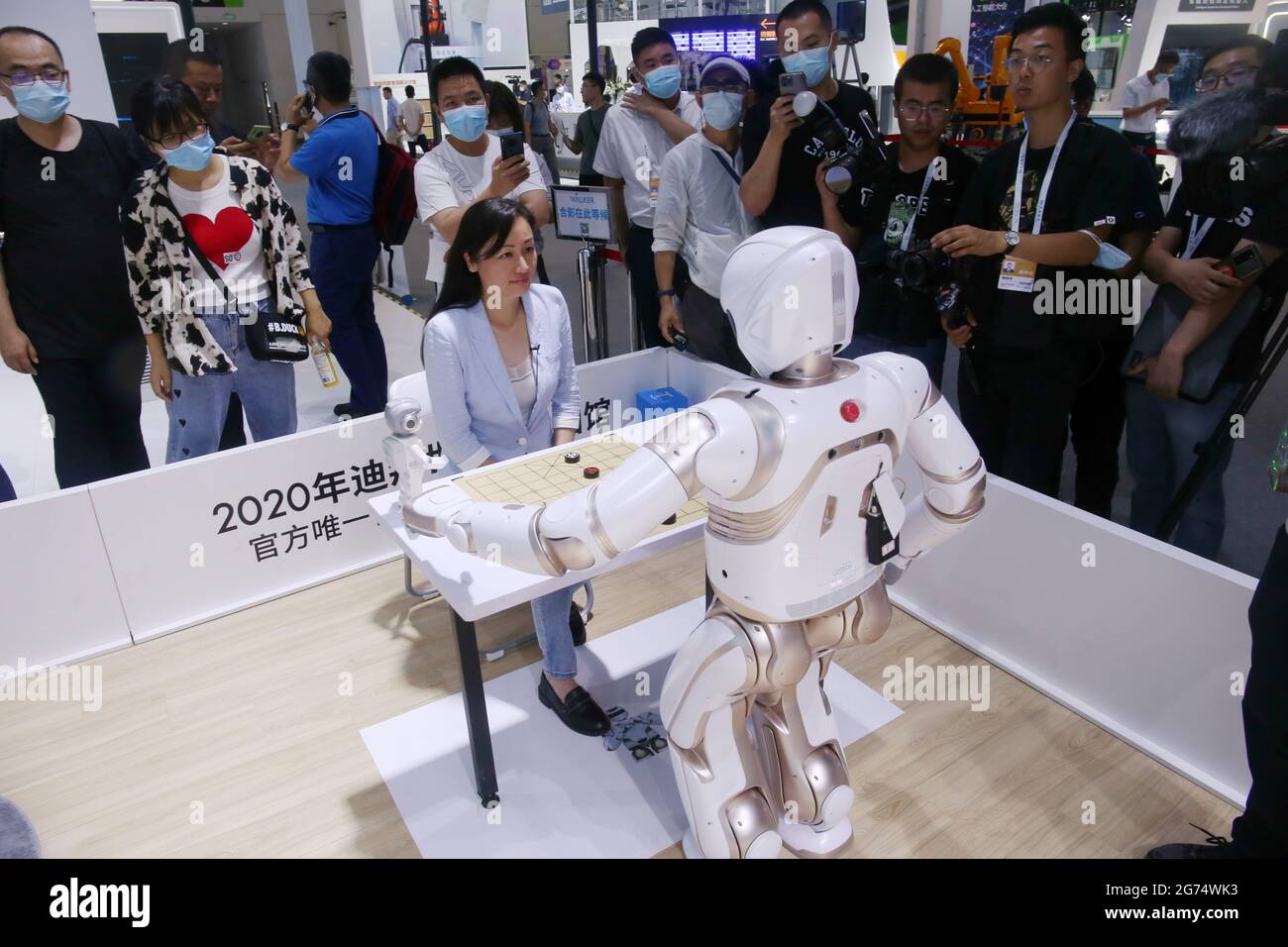 SHANGHAI, CHINA - JULY 7, 2021 - A humanoid service robot plays Chinese chess with a human ...