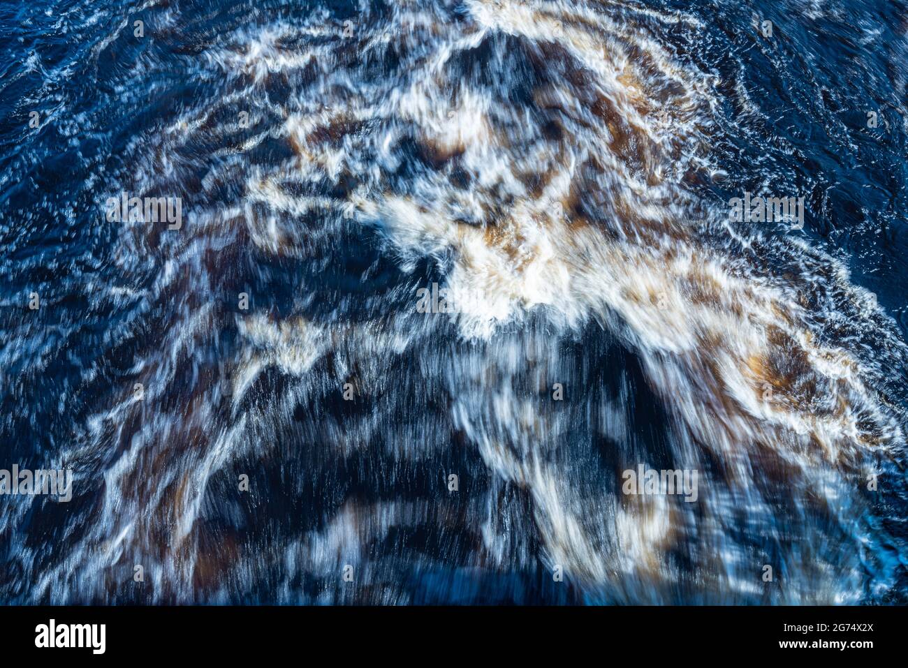 Brown water rushing down a river Stock Photo - Alamy