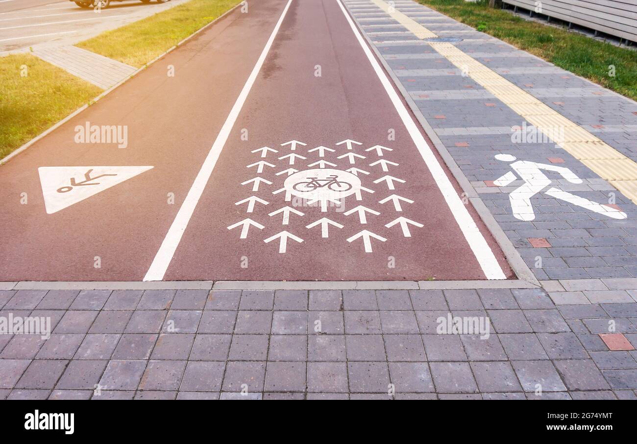 Cycle lane, running track and a pavement. Cycle path marked with signs ...