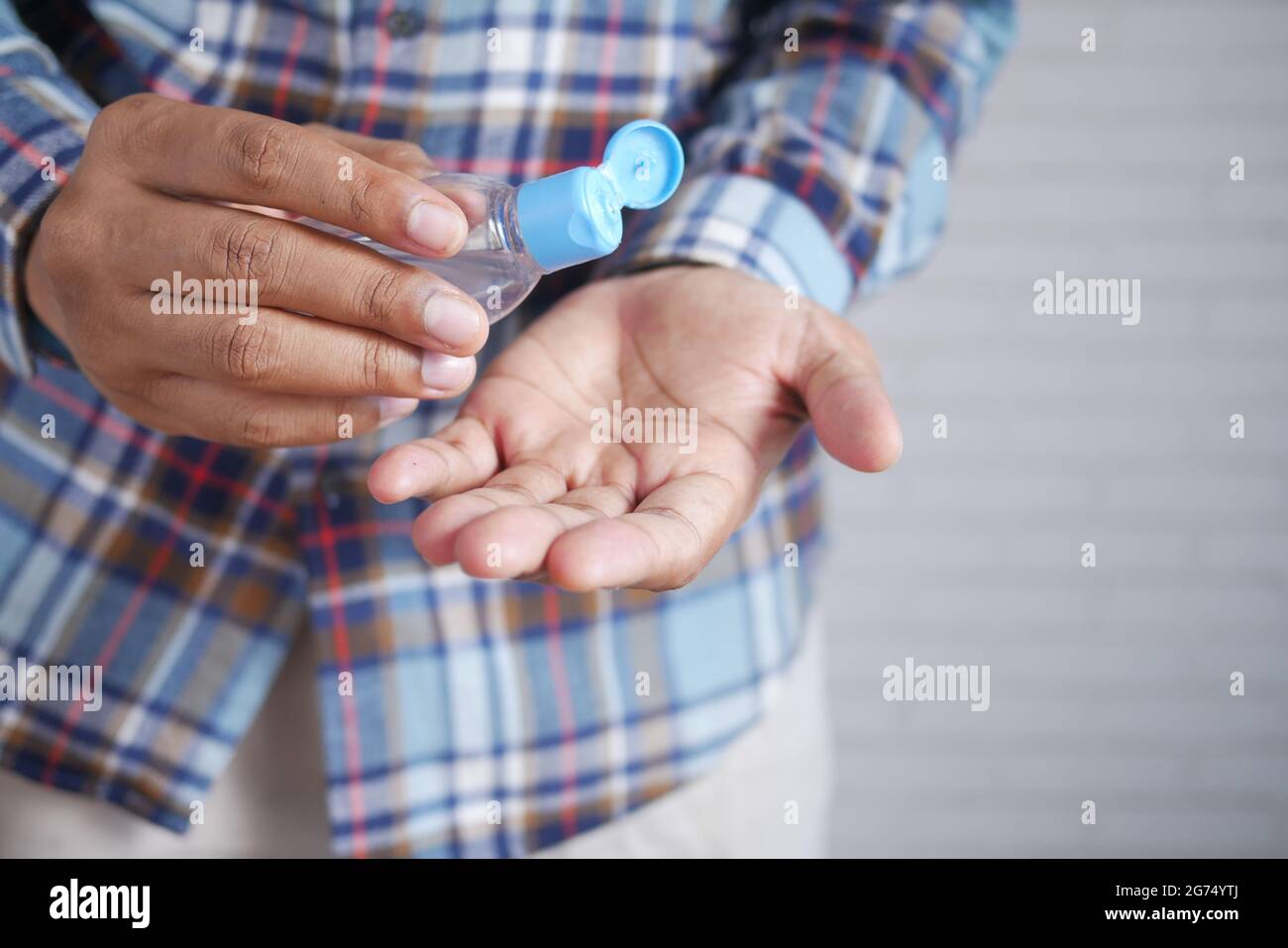 Using sanitizer liquid for preventing corona virus Stock Photo - Alamy