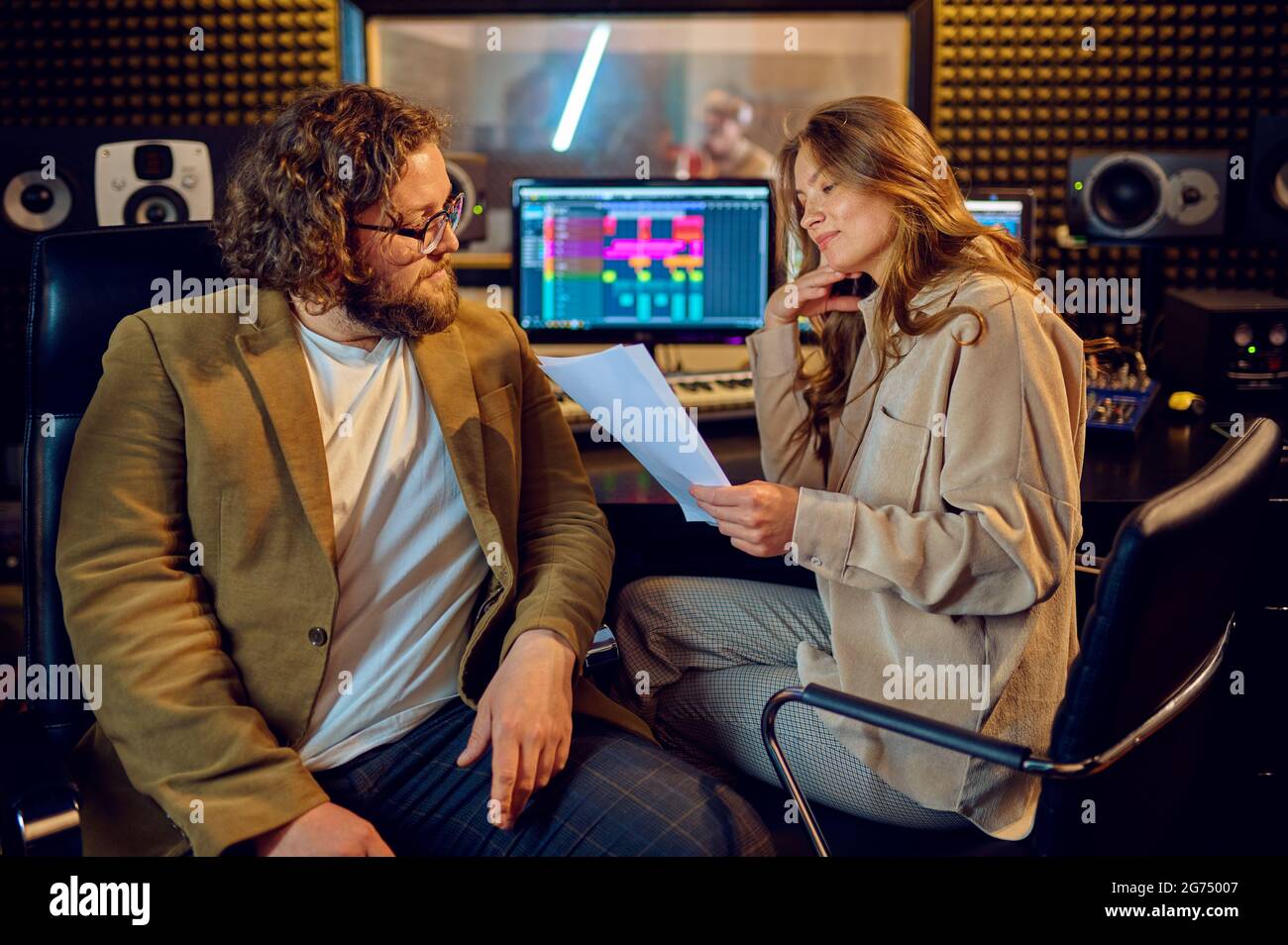 Musicians at mixing console, recording studio Stock Photo - Alamy