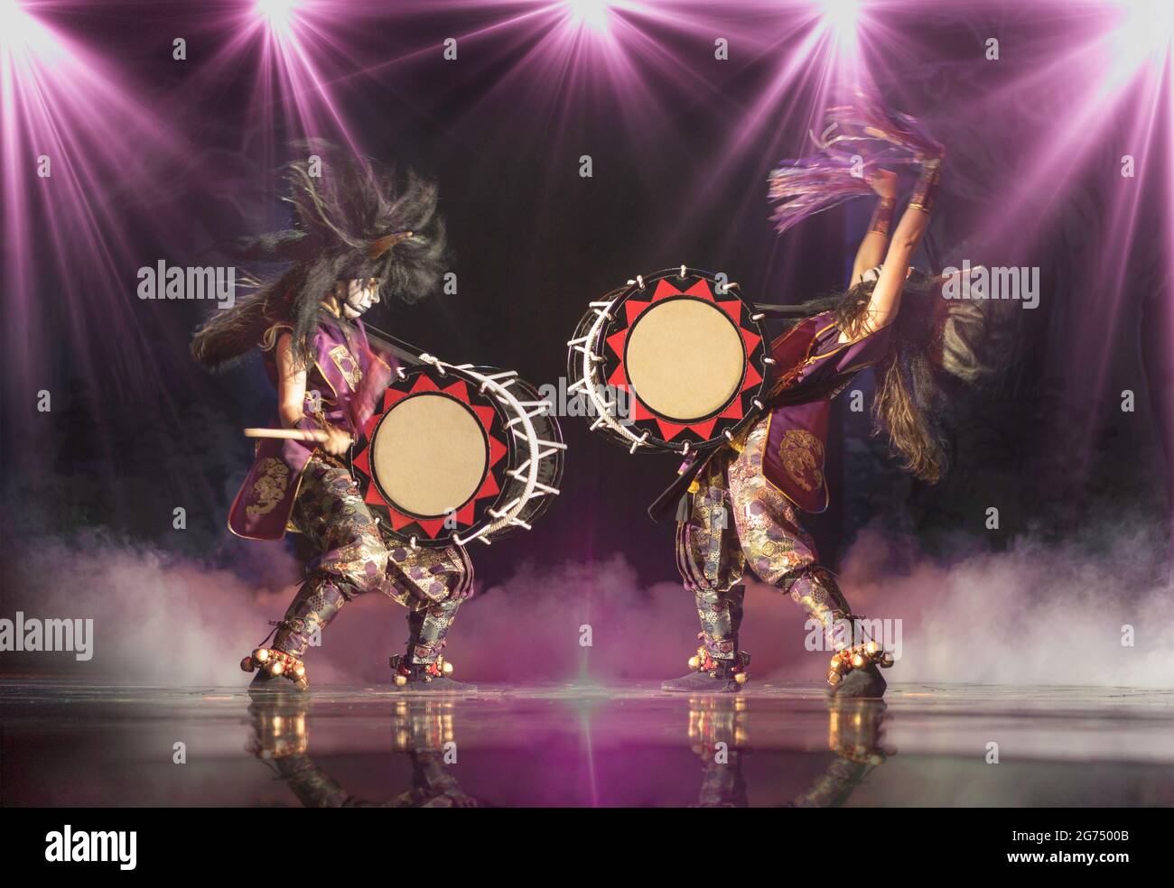 Taiko drummers on the stage. Expressive dynamic poses, stage lighting ...