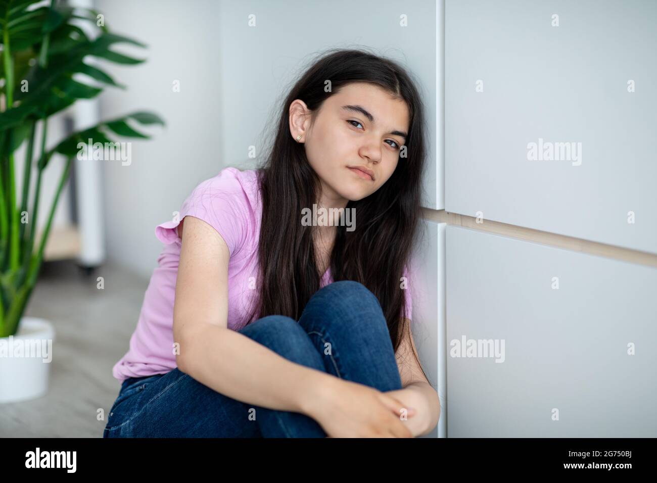 Portrait of Indian teen girl feeling upset and depressed, looking at ...