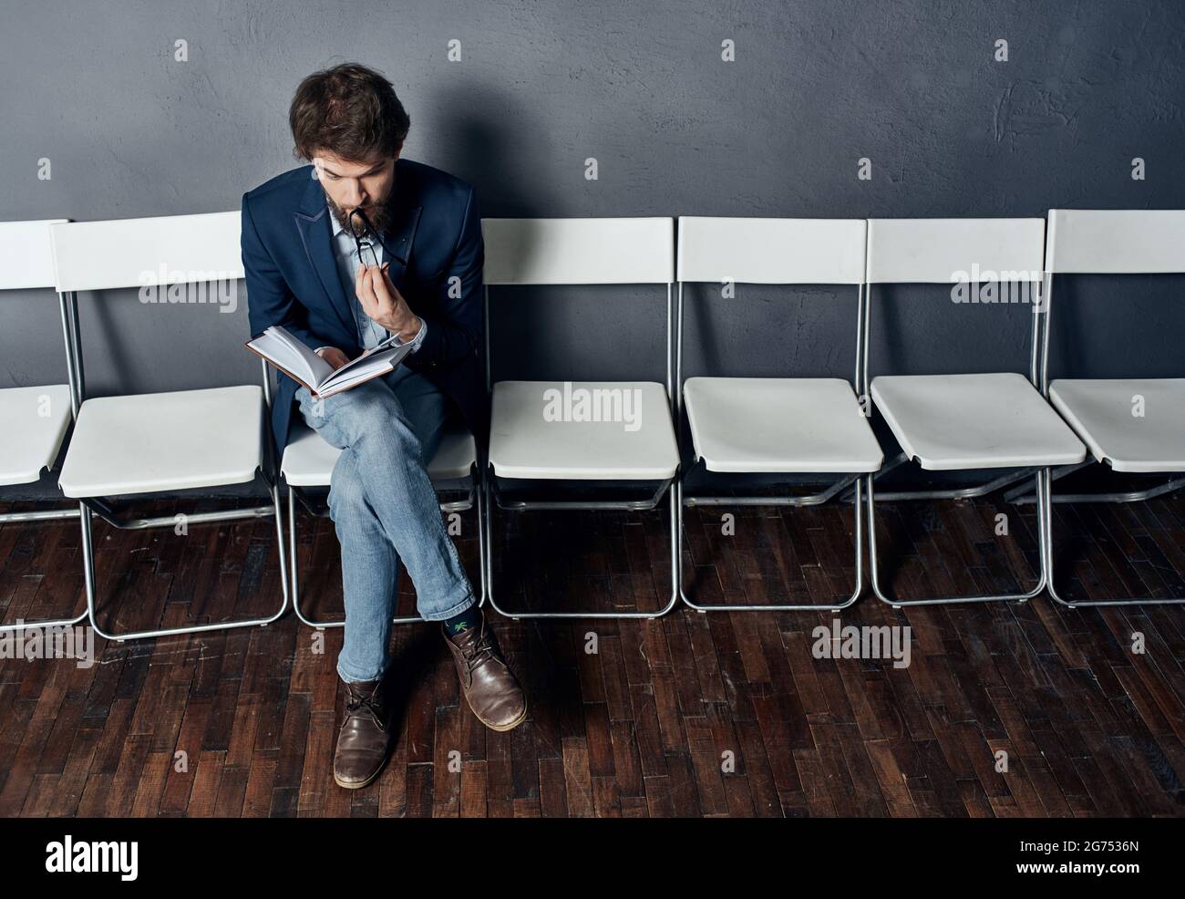 business man sitting on a chair with a notebook work waiting job ...