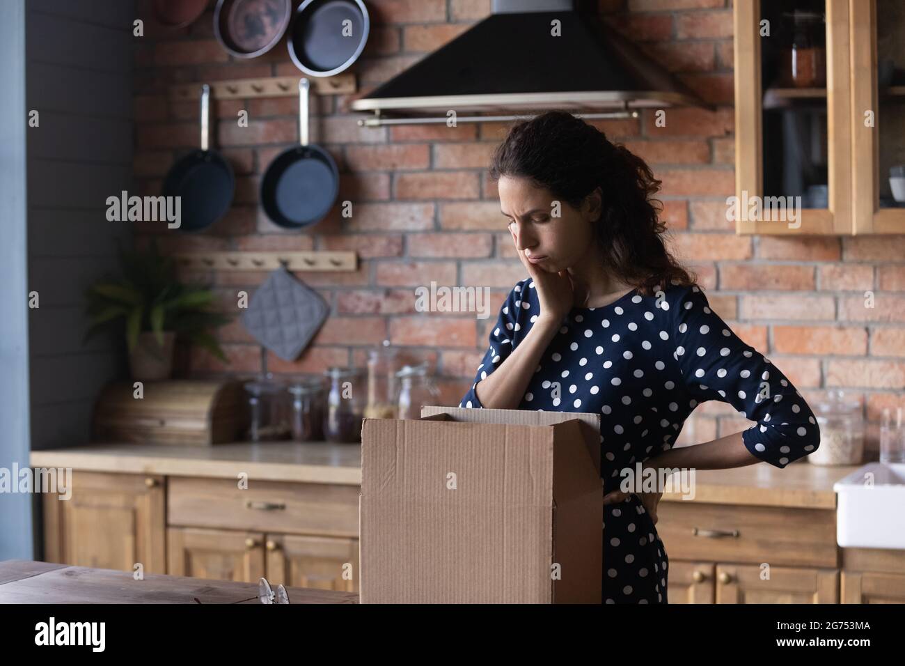 Disappointed customer getting and opening box from internet store Stock ...