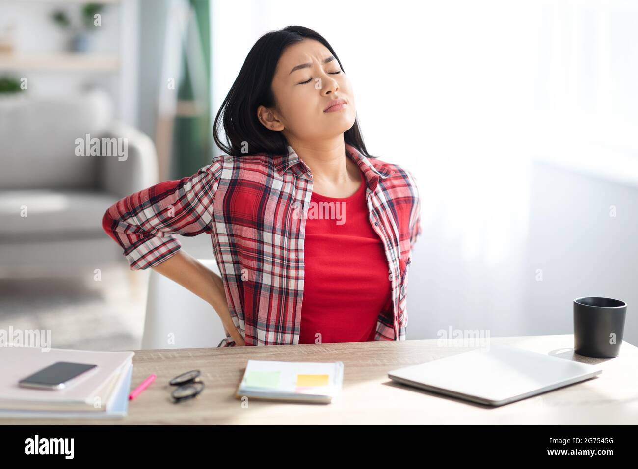 Woman backache home interior hi-res stock photography and images - Alamy