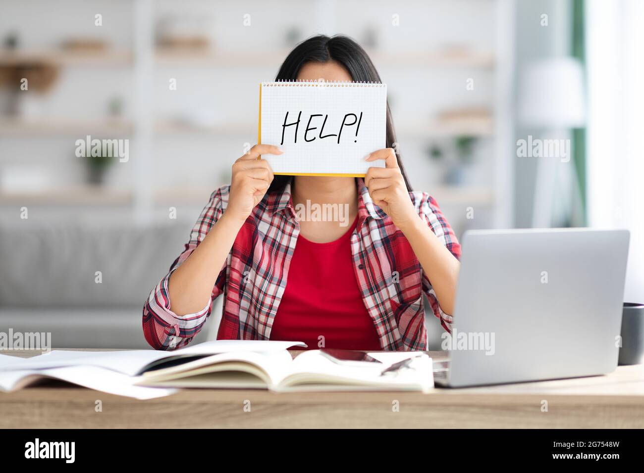 Female Student Holding Leaflet With Drawn Help Word In Front Of Face ...
