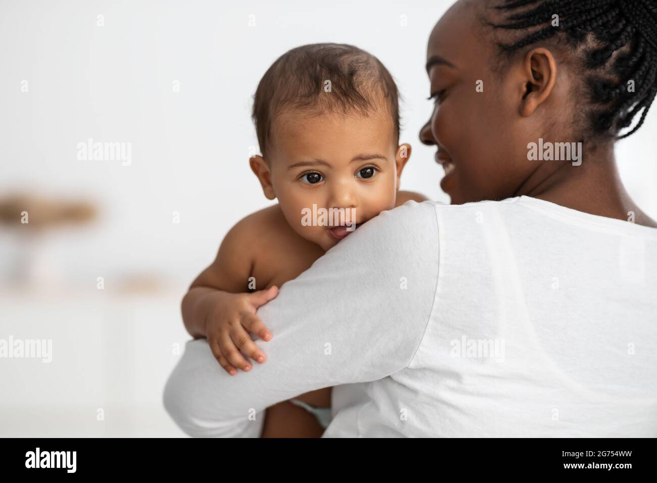Happy African American lady hugging her cute child Stock Photo - Alamy