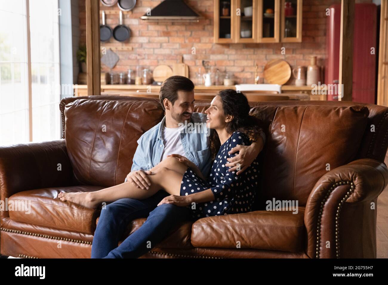 Millennial couple relaxing at home, resting on couch together Stock ...