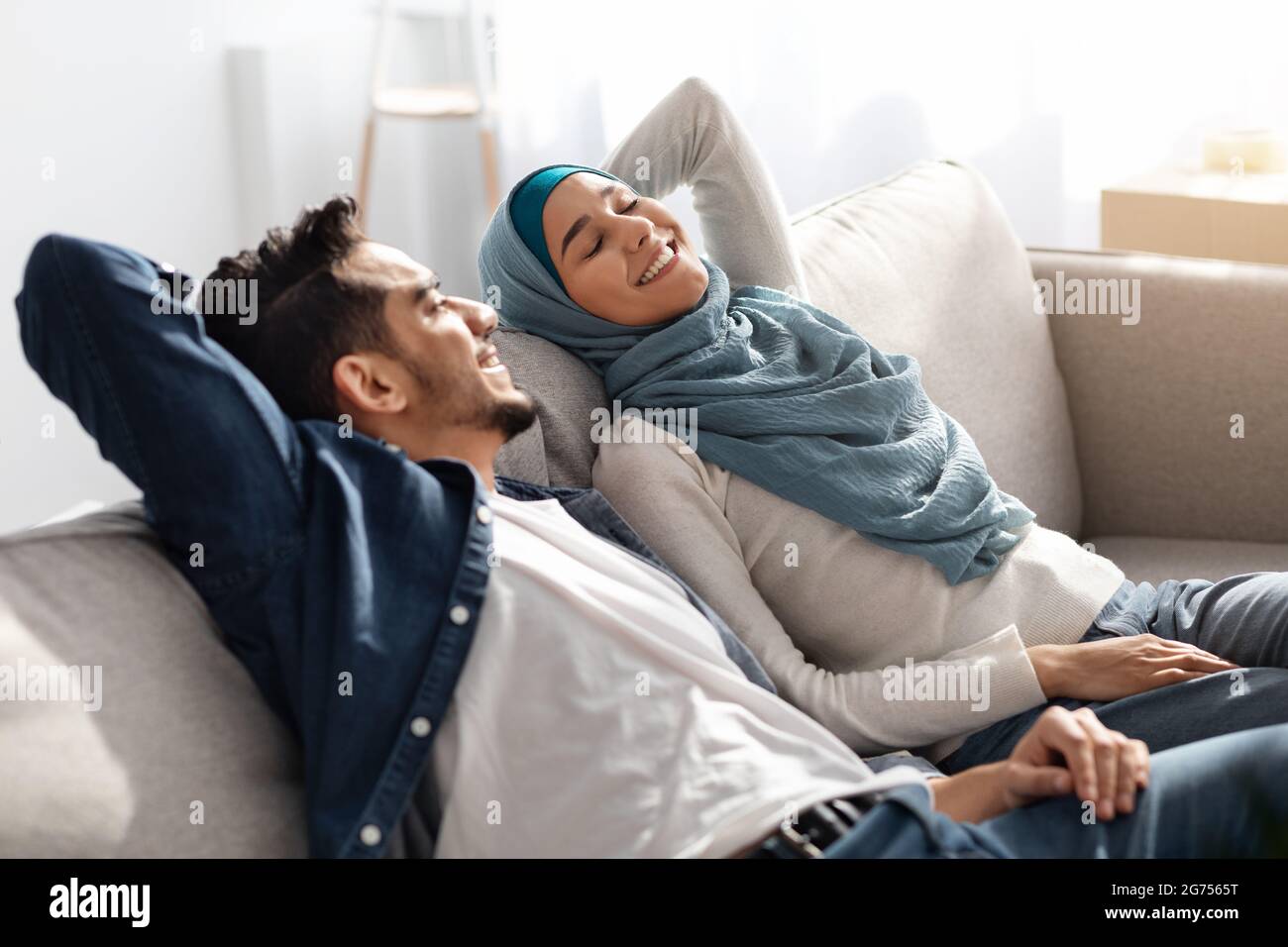 Relaxed muslim family resting after moving to their new house Stock ...