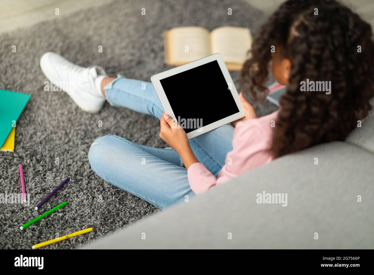E-learning concept. African american schoolgirl using digital tablet ...
