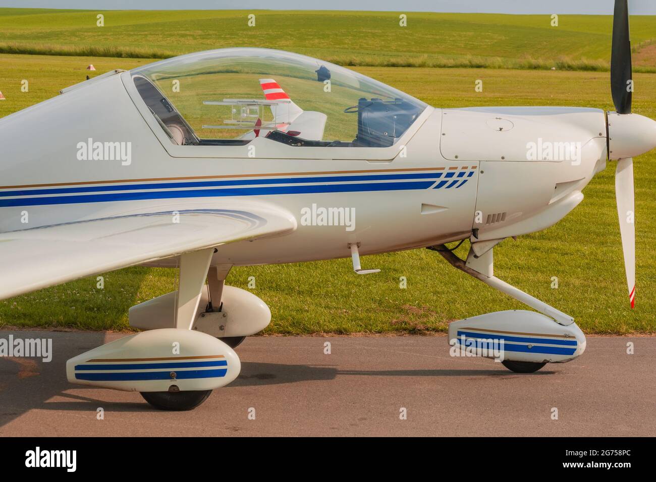 A small sport plane with propeller parked on the airfield Stock Photo ...